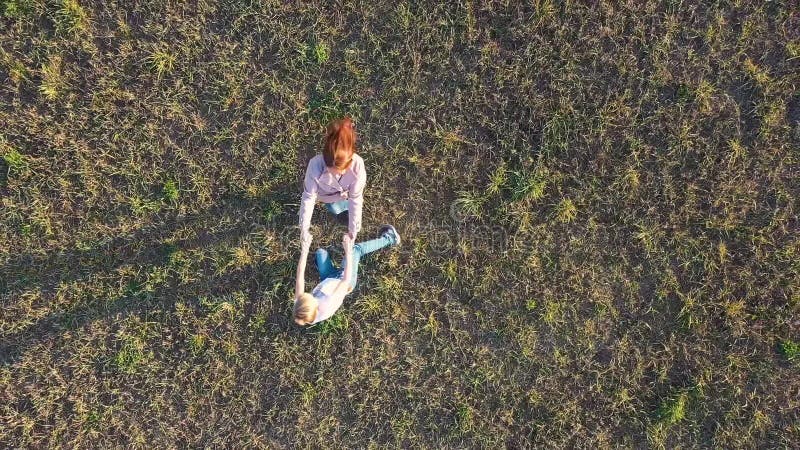 The Girl and the Guy Spin Around Held by Hands on the Field Stock ...