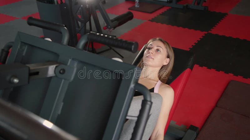 The Girl is at the Gym Doing the Leg Press Machine. Stock Video - Video ...