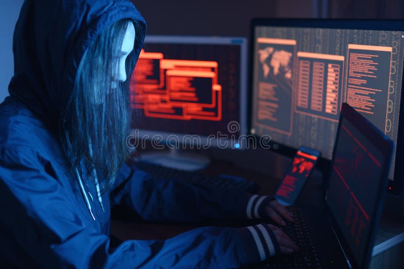 Girl Hacker in a Hood Typing Program Code while Committing a Cybercrime ...