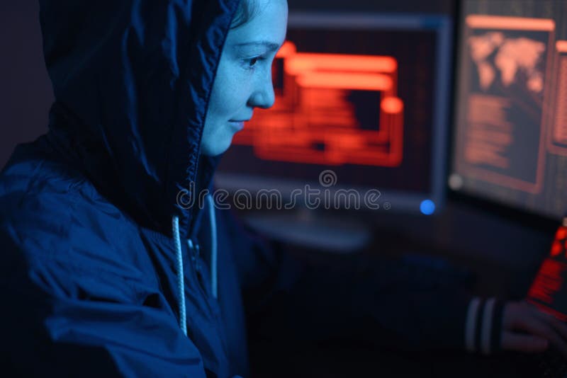 Girl Hacker in a Hood Typing Program Code while Committing a Cybercrime ...