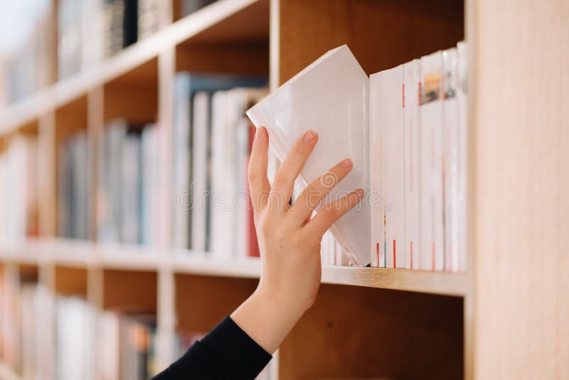 Girl Hand Picking a Book on a Library Shelf Stock Photo - Image of book ...
