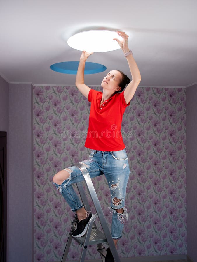 The Woman in the Room Sets the Led Ceiling Light. Stock Image - Image ...