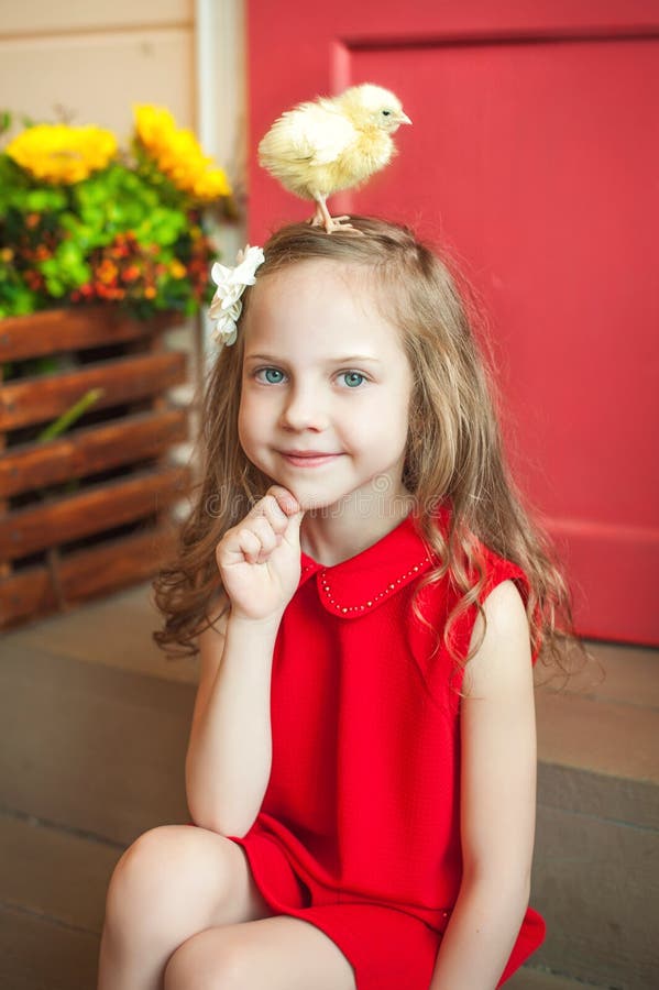 The Girl Has a Chicken on Her Head. Closeup Portrait of a Girl. Easter ...