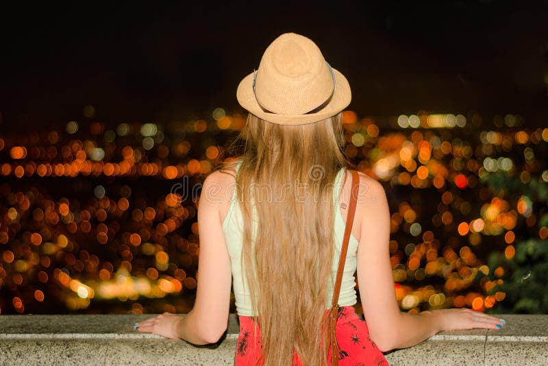 Girl in a Hat Admires the Night City. Back View Stock Photo - Image of ...