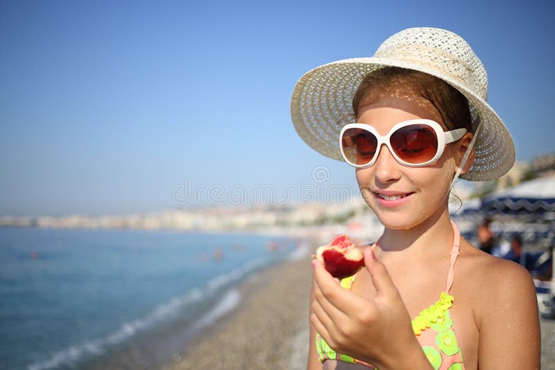 Girl in Hat and Sunglasses Eats Red Peach on Beach Stock Photo - Image ...