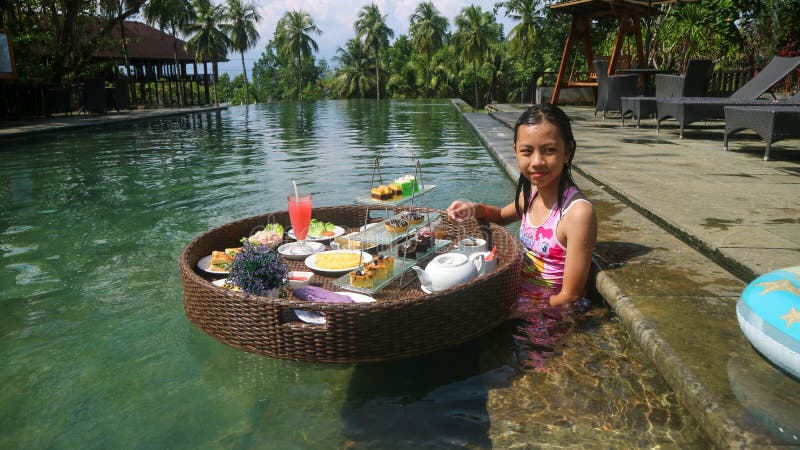 A Girl Having Breakfast Floating in the Pool Stock Image - Image of ...
