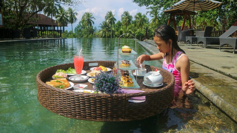A Girl Having Breakfast Floating in the Pool Stock Image - Image of ...