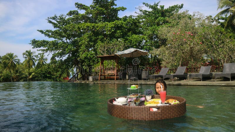 A Girl Having Breakfast Floating in the Pool Stock Image - Image of ...