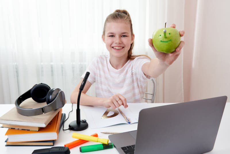 Girl Having Fun with Green Apple while Doing Homework, Joy Concept ...