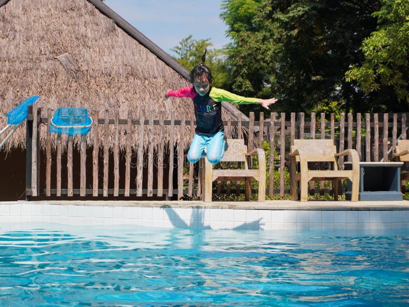 Girl Having Fun Jumping into the Pool. Summer Holidays and Vacation ...