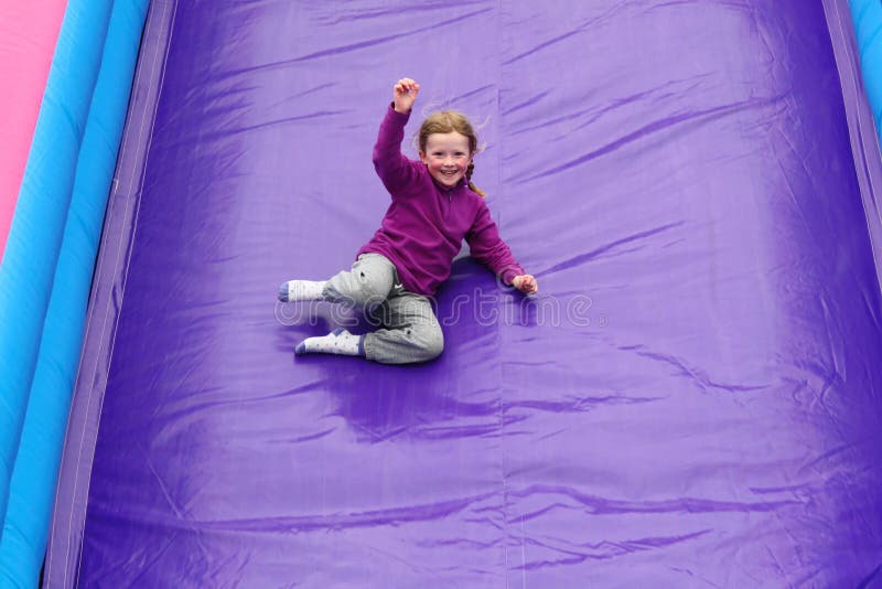 Girl Having Fun on Slide stock image. Image of purple - 57043479