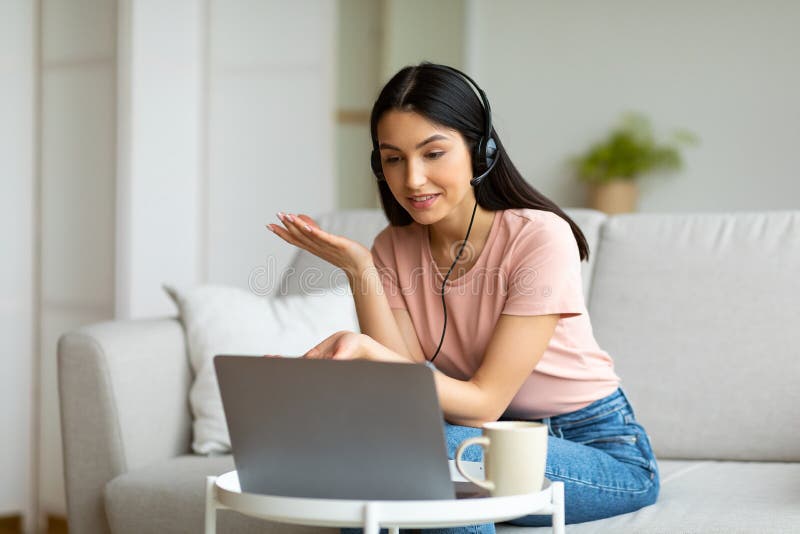 Girl Making Video Call Using Laptop Sitting on Couch Indoors Stock ...