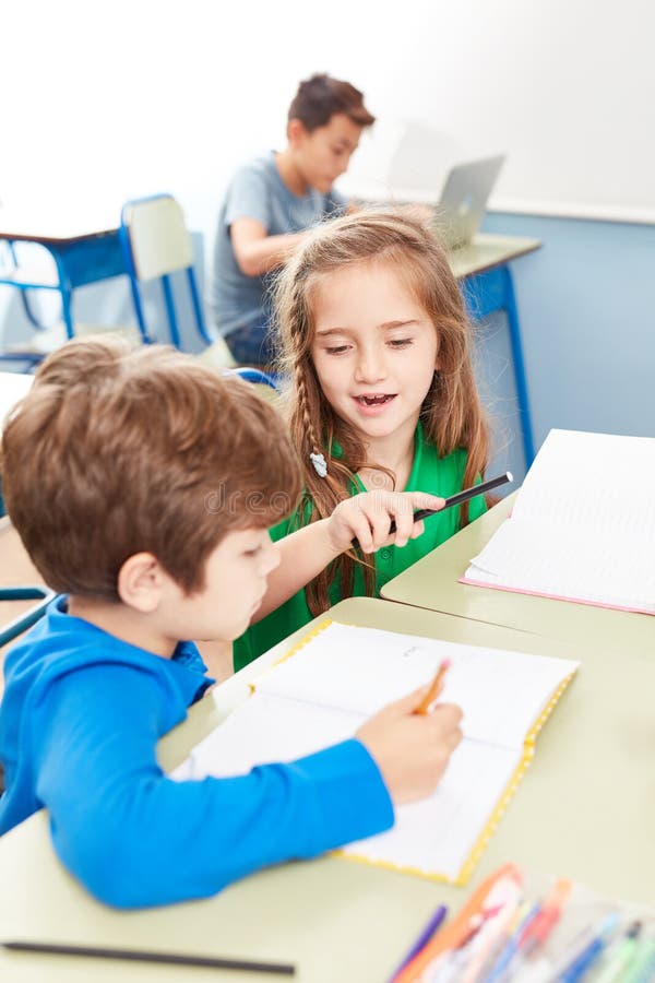 Girl Helps a Boy in the Classroom Stock Image - Image of group, desk ...