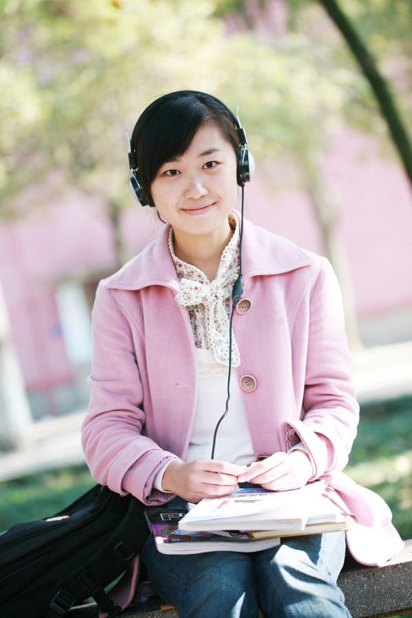 Girl hold headset and book stock image. Image of education - 7587277