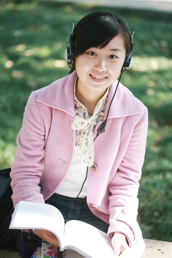 Girl hold headset and book stock image. Image of beautiful - 7587323