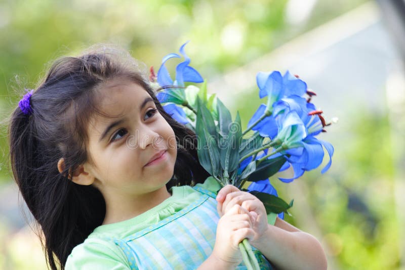 Girl Holding Blue Flowers stock image. Image of latina - 4057869