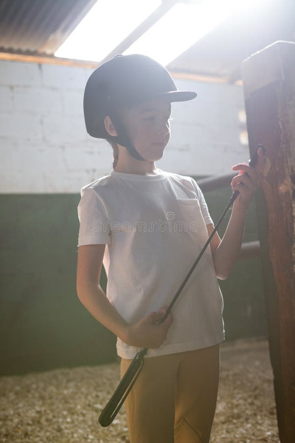 Girl Holding Crop Stick in Stable Stock Image - Image of expertise ...