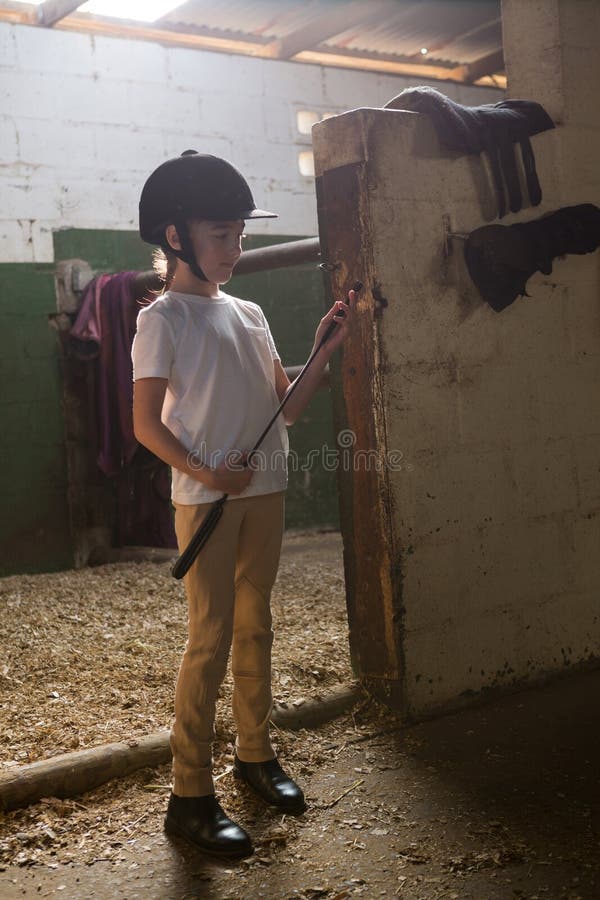 Girl Holding Crop Stick in Stable Stock Image - Image of adorable ...