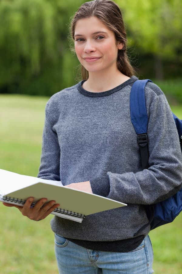 Girl Holding Her Notebook while Carrying Her Backp Stock Photo - Image ...