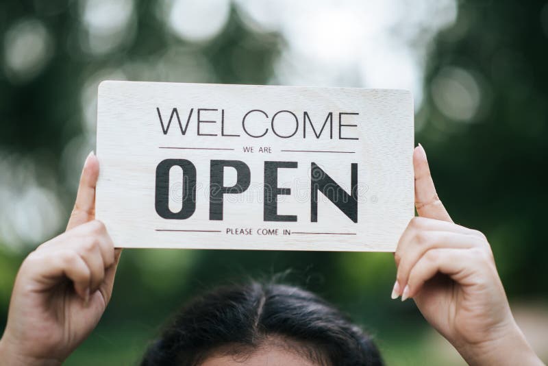 Girl holding open sign stock photo. Image of board, people - 164002706