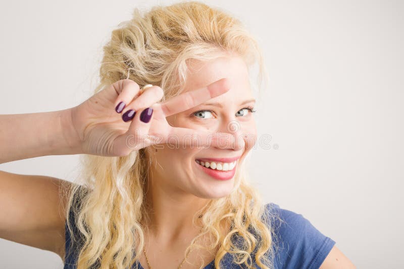 Girl Holding Two Fingers in Front of Her Face Stock Image - Image of ...