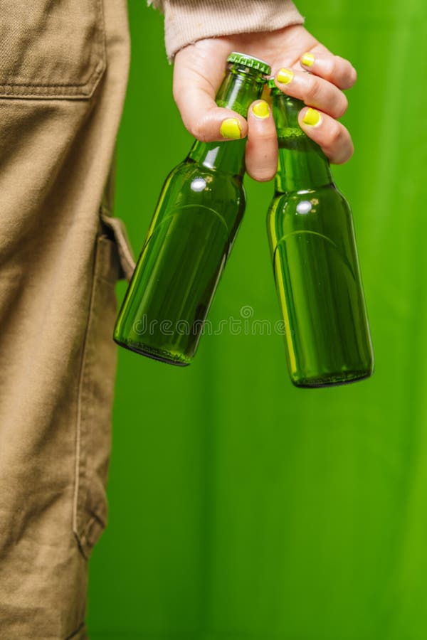 A Girl Holding Two Green Beer Bottles Stock Photo - Image of alcohol ... A Girl Holding Two Green Beer Bottles Stock Photo - Image of alcohol ...