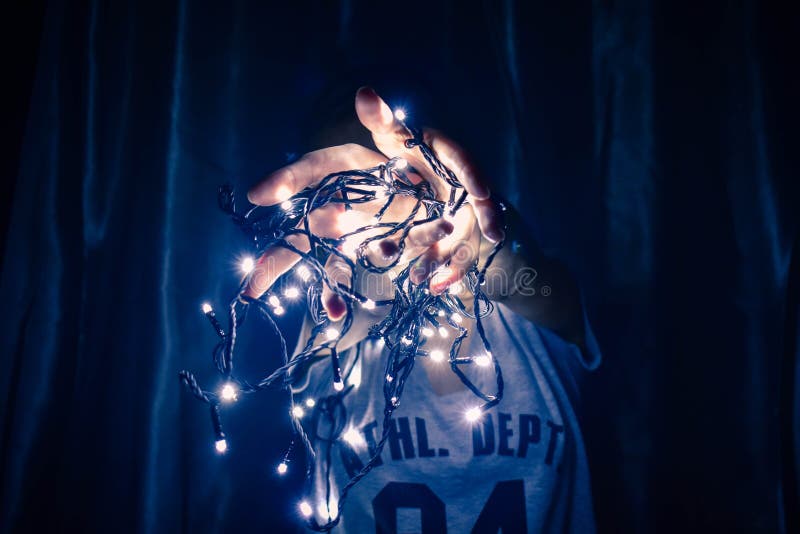 A Girl Holds in Front of the Camera Their Hands Wrapped in a Garland ...