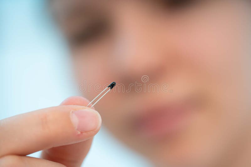 Girl Holds in Her Hands a Semiconductor Temperature Sensor for Devices ...
