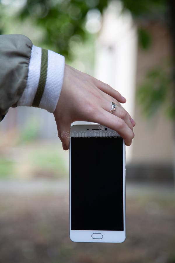 Girl Holds the Phone in His Hand. Place Under the Text Stock Image ...