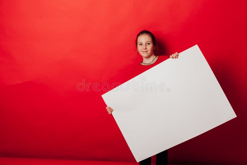 A Girl Holds a Sign for Writing on a Red Background Stock Photo - Image ...