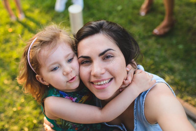Girl Hugging Mother s Legs stock photo. Image of cute - 40076012