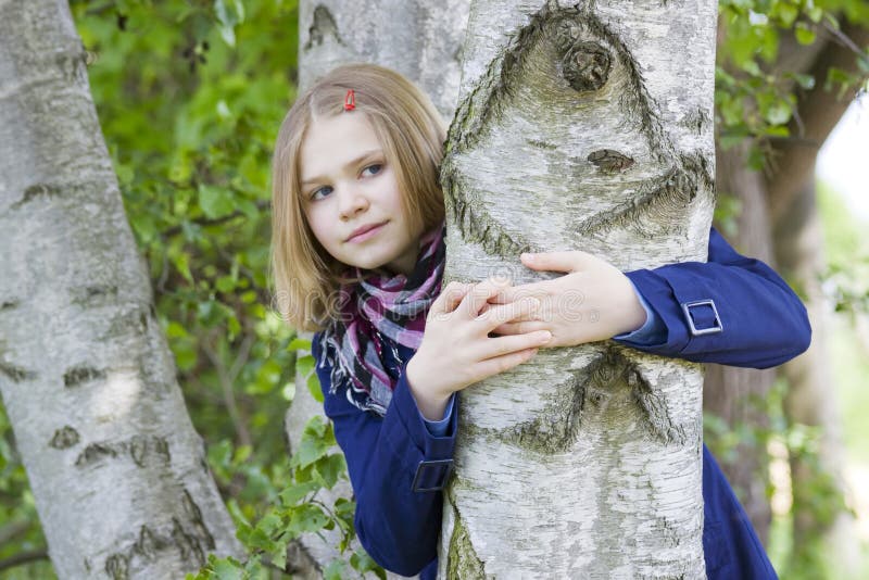 Girl hugging tree trunk stock photo. Image of hugging - 25067386