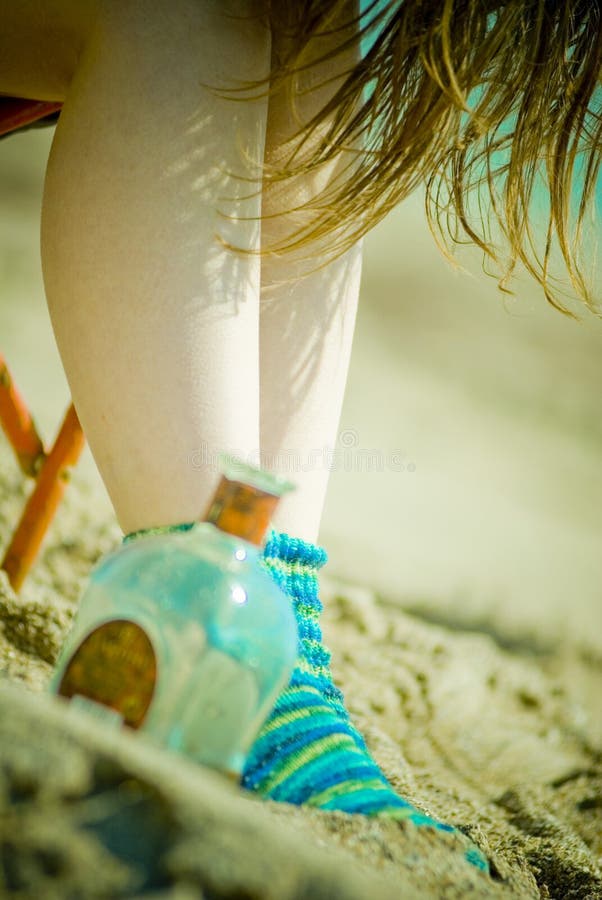 Girl hunched over a bottle stock photo. Image of beach - 2540820