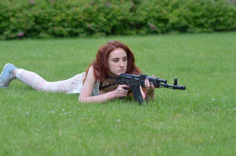 Girl with a hunting rifle stock photo. Image of green - 50224344