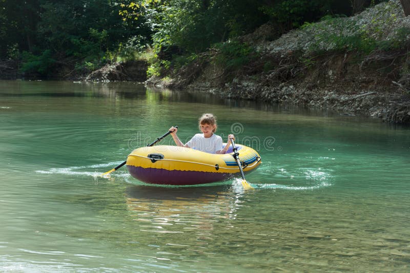 Girl in inflatable boat stock photo. Image of river, green - 21627084