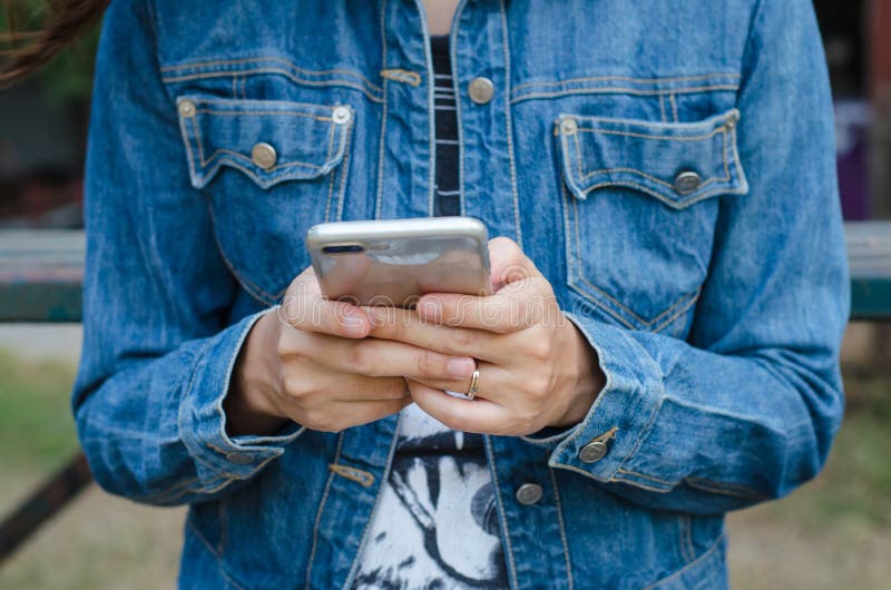 Girl in Jeans Jacket Using Smart Phone Stock Image - Image of ...