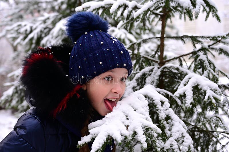 The Girl Jokingly Eats Snow in Winter. Stock Photo - Image of smile ...