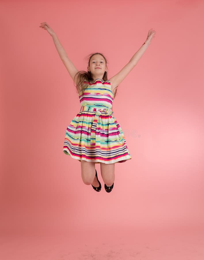 Girl in a Jump on a Pink Background Stock Photo - Image of studio, jump ...