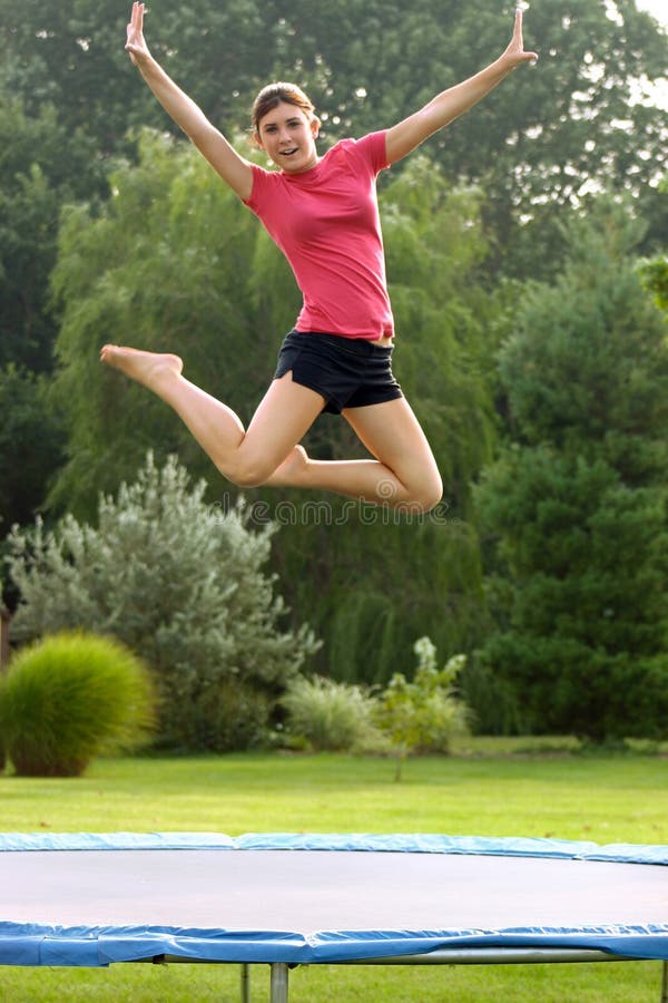 Girl Jumping on a Trampoline. Stock Photo - Image of entertaining ...