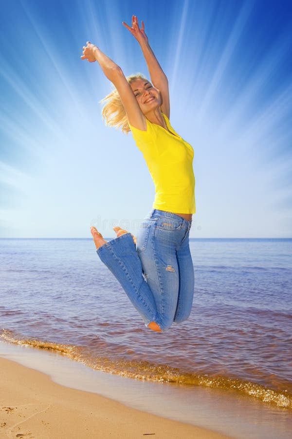 Girl jumping on the beach stock image. Image of blue, carefree - 2514513