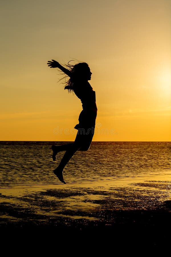 Girl Jumping on the Beach with the Sun. Stock Photo - Image of woman ...