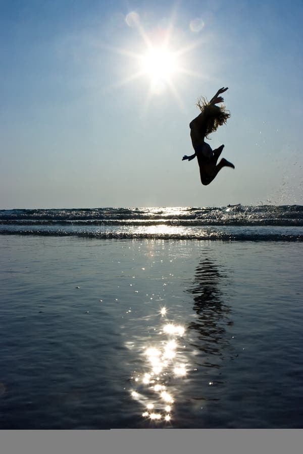 Girl jumping high stock photo. Image of beam, lady, ocean - 8080370