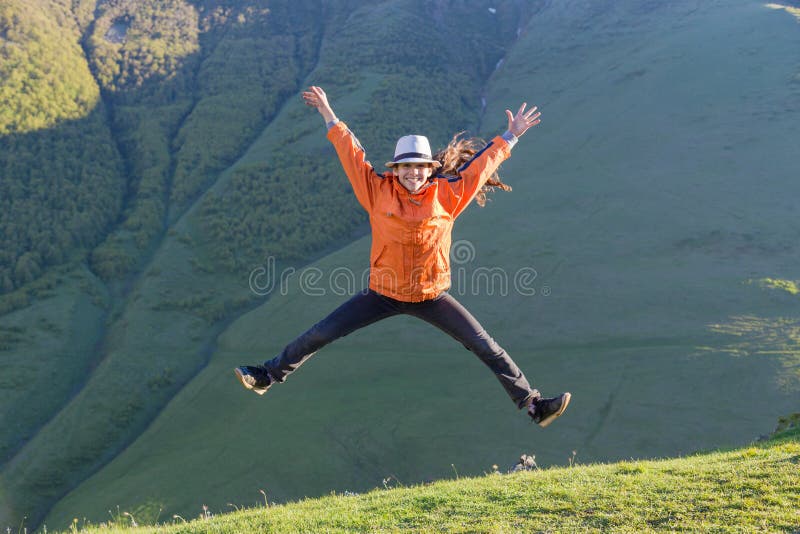 Girl jumping on hill stock photo. Image of girl, people - 73707964