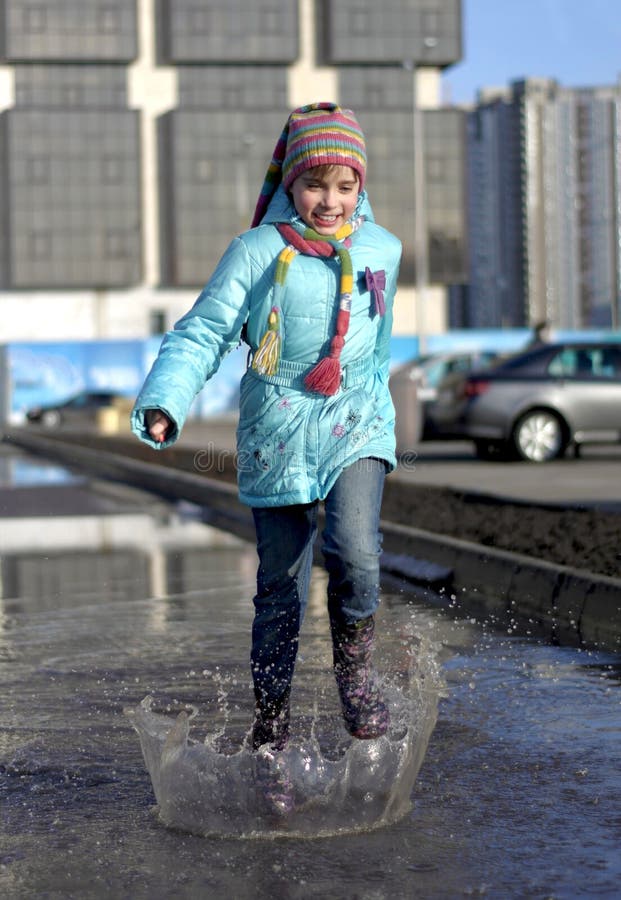 Girl Jumping in the Puddles Stock Photo - Image of running, water: 40087378