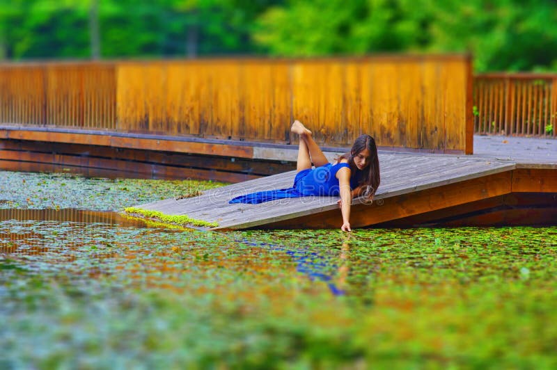 Girl by the lake posing 5 stock photo. Image of beach - 95956156