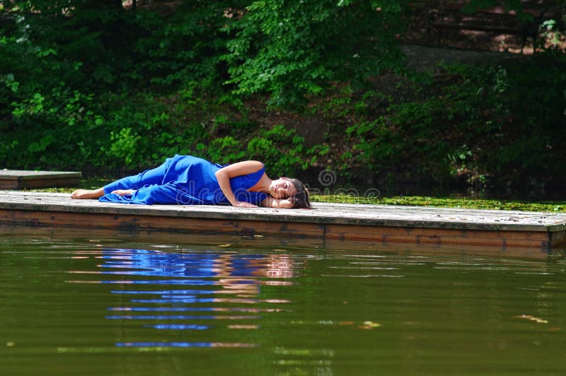 Girl by the lake posing 4 stock image. Image of light - 95956385