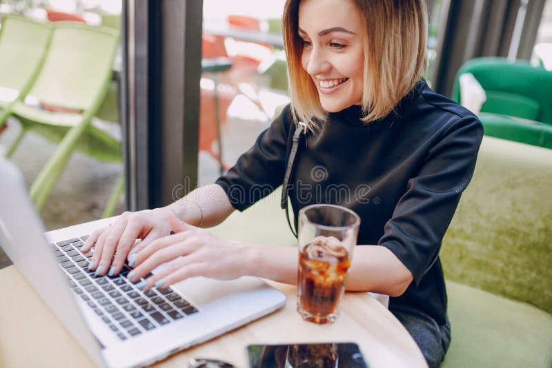 Girl laptop cafe cocktail stock photo. Image of looking - 90082104