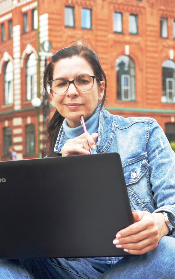 Girl with Laptop and Notepad Stock Photo - Image of focused, indoors ...