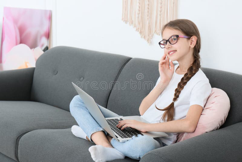 Girl with laptop on sofa stock image. Image of network - 225830023