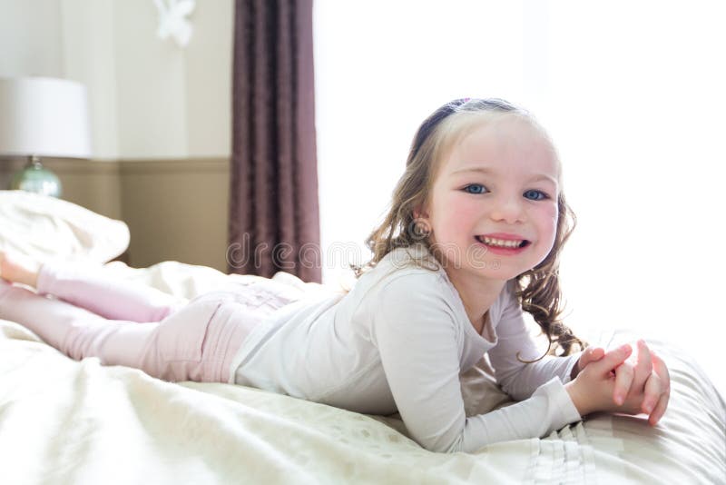 Girl lay bed at home stock photo. Image of little, lying - 100374188